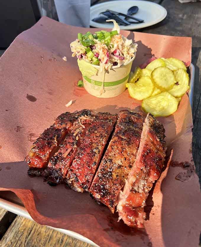 Ribs so tender they practically wave goodbye to the bone, served on butcher paper like edible art.