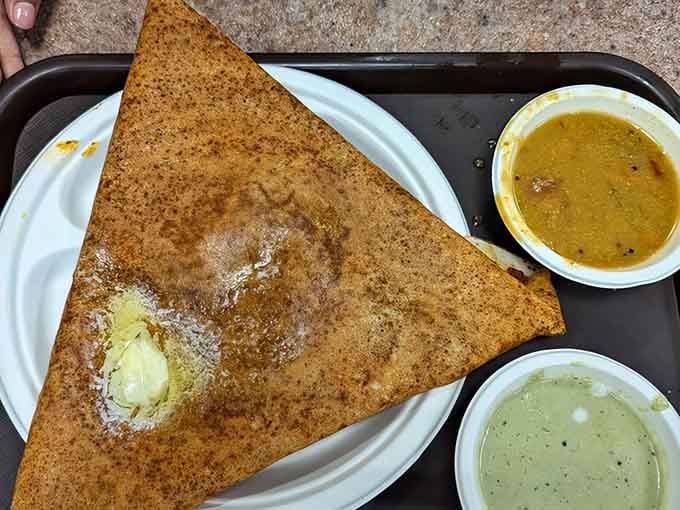 That golden triangle of crispy perfection is a paneer masala dosa, stuffed with spiced goodness and ready to rock your world.