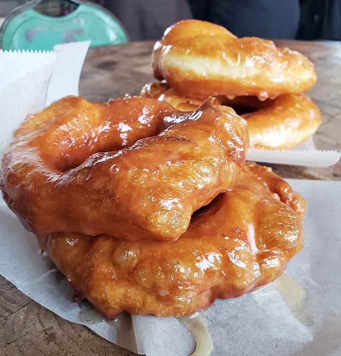 Golden, glistening, and gloriously imperfect, these glazed beauties look like they just won the donut lottery.