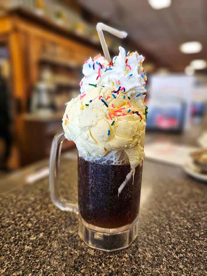 A root beer float crowned with vanilla ice cream and rainbow sprinkles, because adulthood means extra toppings.