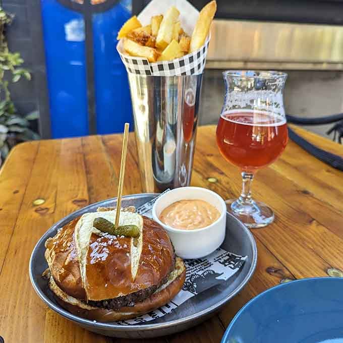 That pretzel bun burger paired with golden frites proves some food combinations were simply meant to be together forever.
