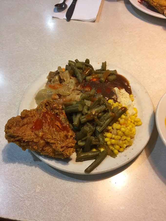 Golden fried chicken with green beans and corn: the holy trinity of Southern comfort on one glorious plate.
