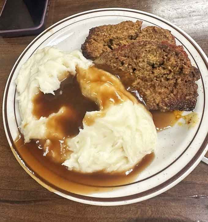 Meatloaf and mashed potatoes swimming in gravy, proving some classics never need updating or improvement.