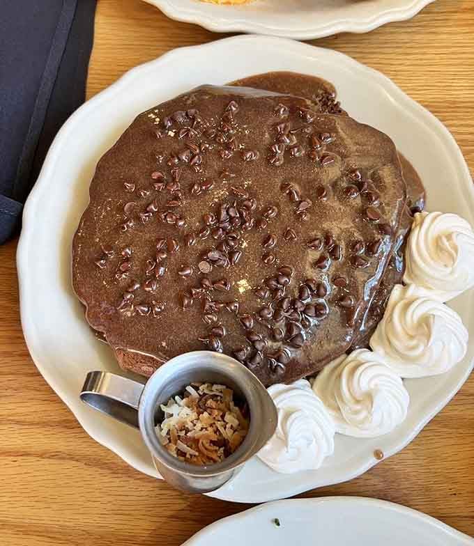 Those chocolate chips studding rich pancakes with toasted coconut pecan sauce prove breakfast can absolutely be dessert without apology.