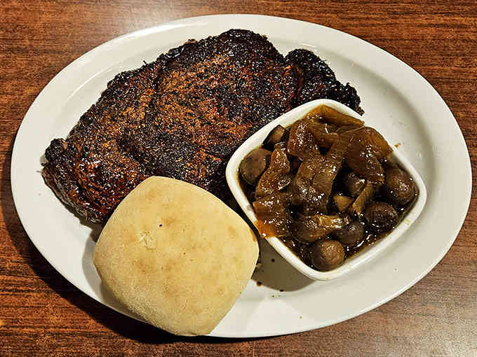 That beautifully charred ribeye with saut&eacute;ed mushrooms is what steakhouse dreams are made of, folks.