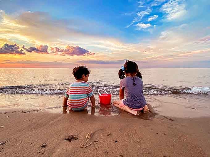 Two kids, one bucket, infinite memories being made at the water's edge right now.