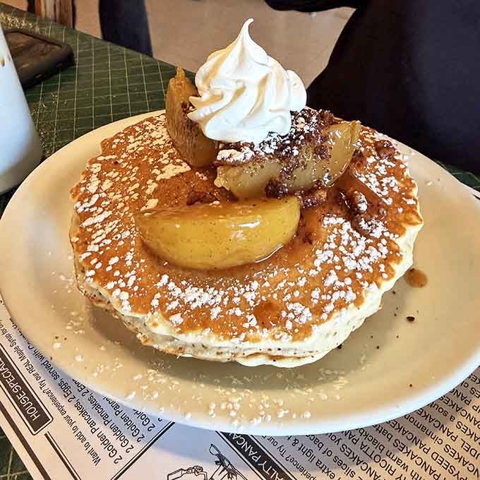The Apple Strudel pancake arrives looking like breakfast won the lottery and decided to celebrate with whipped cream.