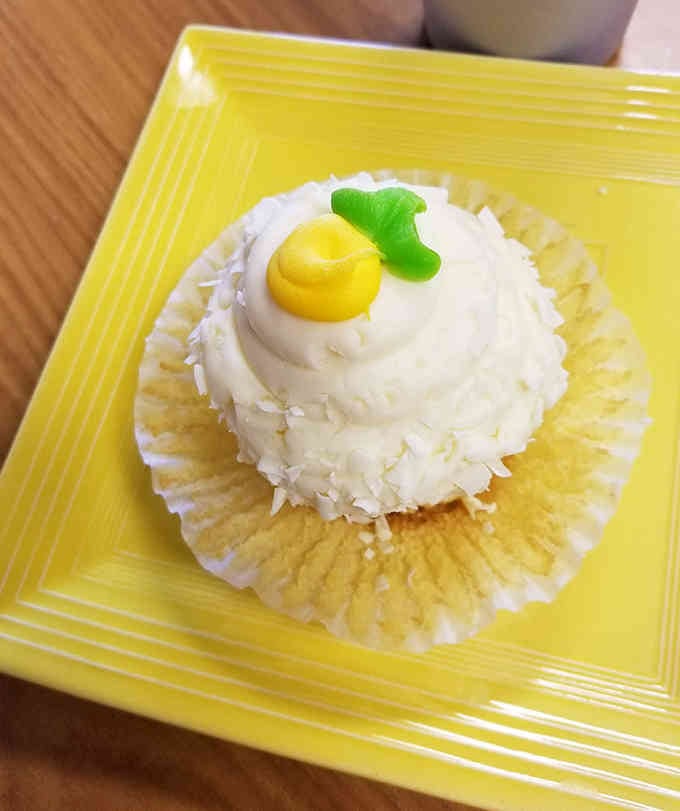 This coconut cream cupcake looks like something straight from a superhero's victory celebration, minus the spandex.