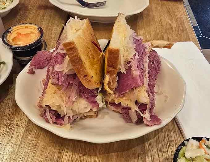 The Reuben stands tall like a delicious skyscraper, engineered for maximum flavor with every impossible bite.