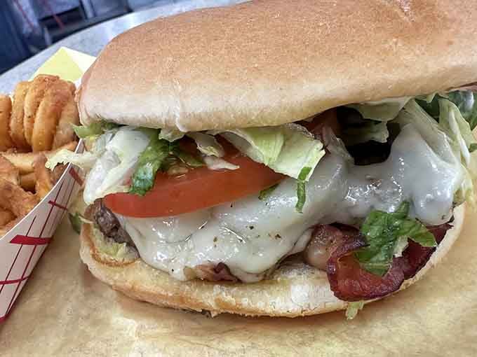 Behold the bacon cheeseburger in all its glory, with cheese cascading like a dairy waterfall over perfectly cooked beef.