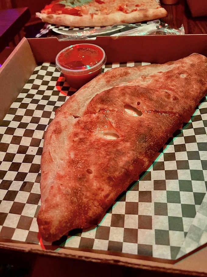 That calzone is bigger than your head and twice as satisfying, a proper New York fold-over done right.