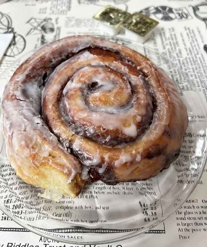 This cinnamon roll could double as a throw pillow, glazed to perfection and utterly irresistible.