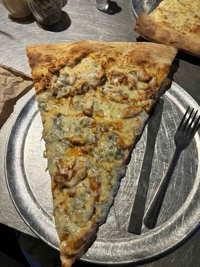 The Buff slice proves that chicken, cheese, and ambition can coexist beautifully on one ridiculously oversized platform.