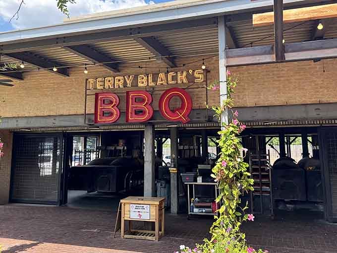 The neon glow promises what the smoke delivers: a barbecue experience that'll ruin you for lesser meats forever.