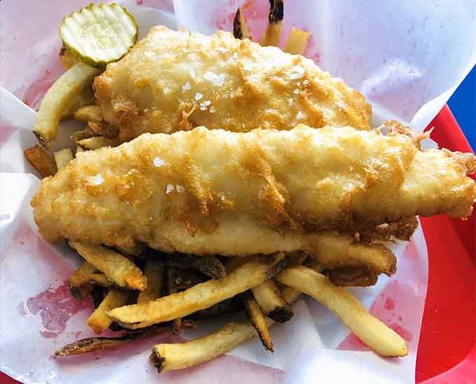 Golden-battered walleye resting on crispy fries is the kind of simple beauty that makes your heart sing with joy.