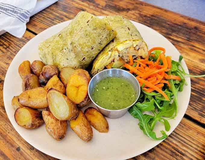 This breakfast burrito wraps scrambled perfection with roasted potatoes and greens, fueling your beachside adventures beautifully.