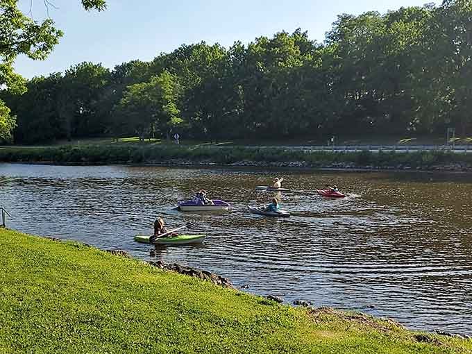 Kayakers gliding along the Rock River, living their best life without needing a vacation package or travel agent.