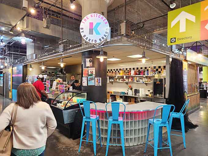Bright blue stools and colorful signage signal that someone here understands food should be fun, not formal.