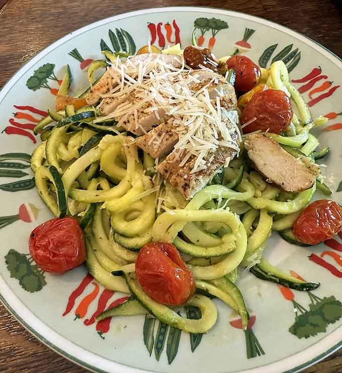Grilled chicken perched atop spiralized zucchini noodles proves healthy eating doesn't have to taste like punishment or sadness.