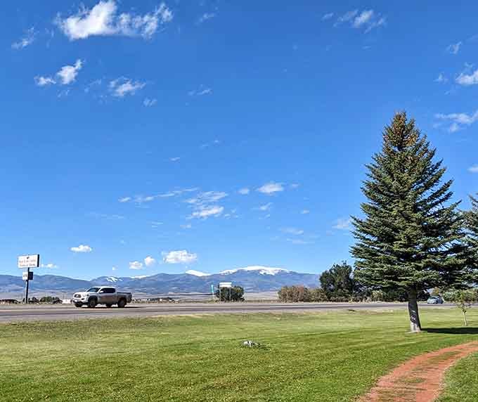 Snow-capped peaks frame emerald grass where kids can roam freely, like a Norman Rockwell painting with altitude.