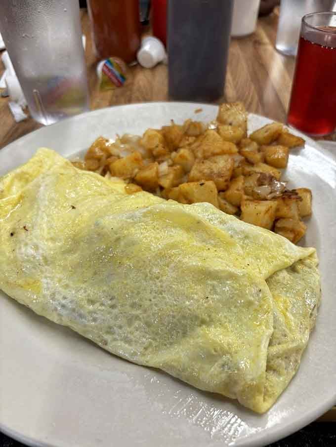 A perfectly folded omelet with golden home fries proves simple done right beats fancy every time.