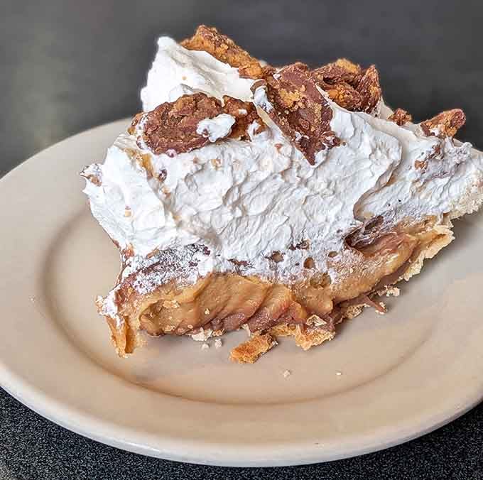 That peanut butter cream pie towers like a delicious skyscraper, proving that architecture can indeed be edible and magnificent.
