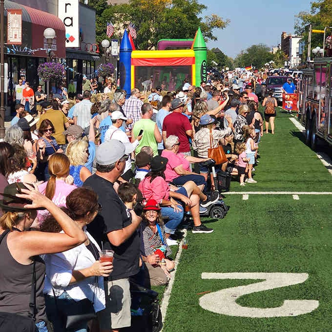 Families line the streets as colorful floats pass by, proving small-town parades still beat streaming services.