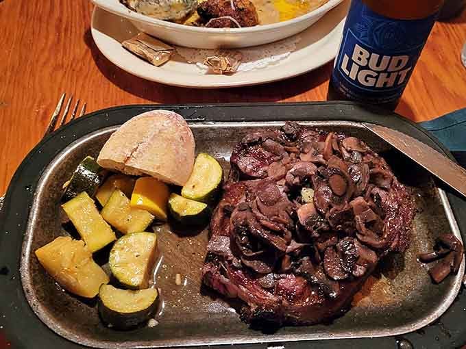 Look at that ribeye with caramelized onions and perfectly roasted vegetables, proof that simple done right beats fancy every time.