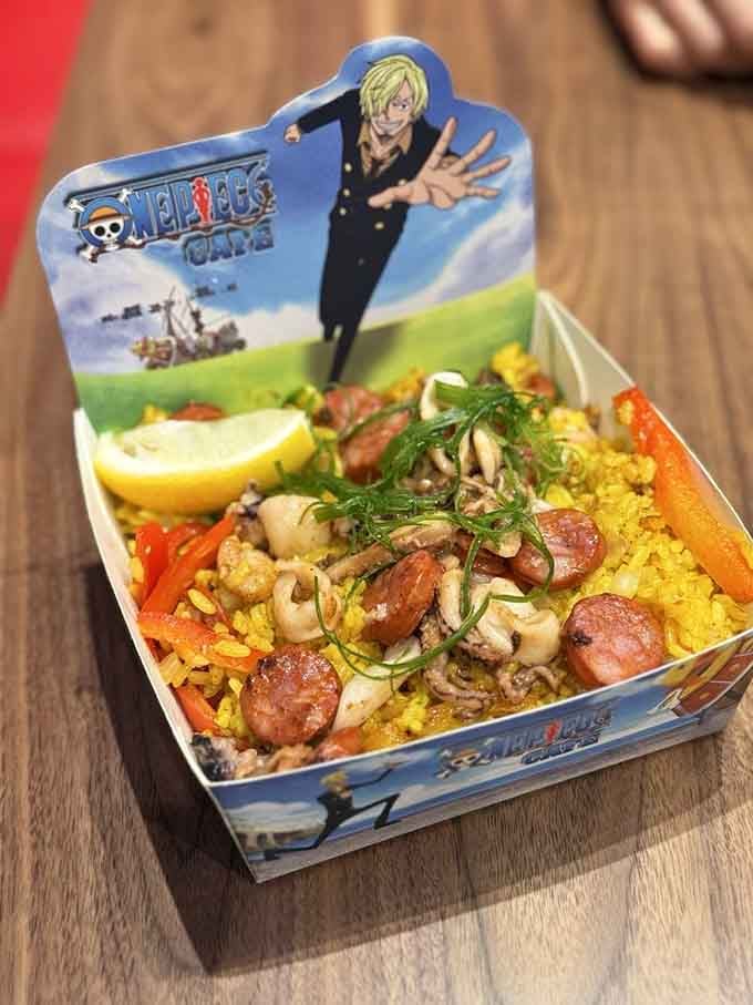 Golden saffron rice studded with plump shrimp and sausage, served in a collectible character tin no less.