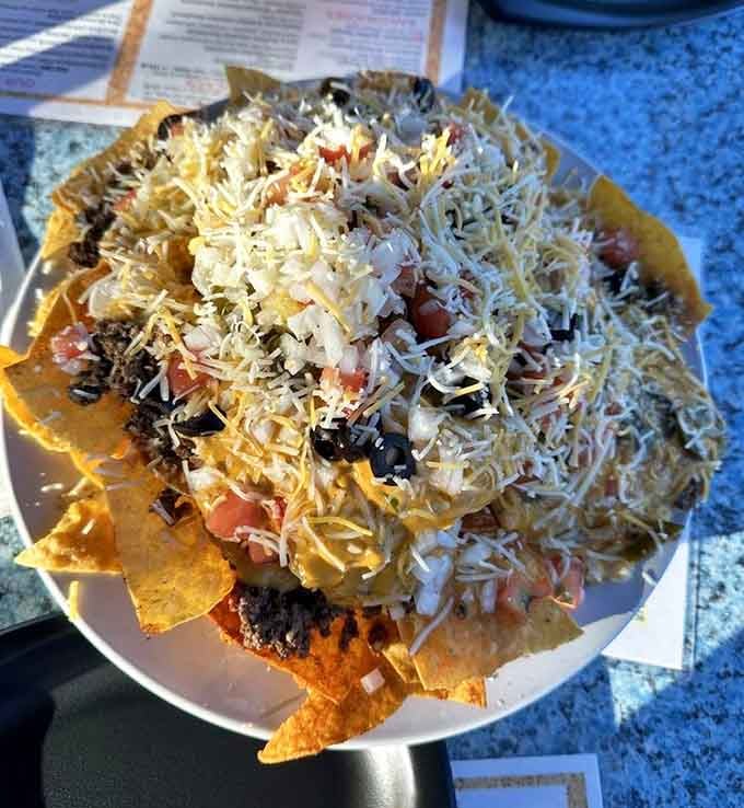 Loaded nachos piled high enough to feed a whole firehouse crew, because wine pairs surprisingly well with cheese.