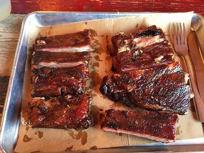 These ribs showcase that perfect smoke ring and bark that barbecue dreams are made of, no exaggeration needed.