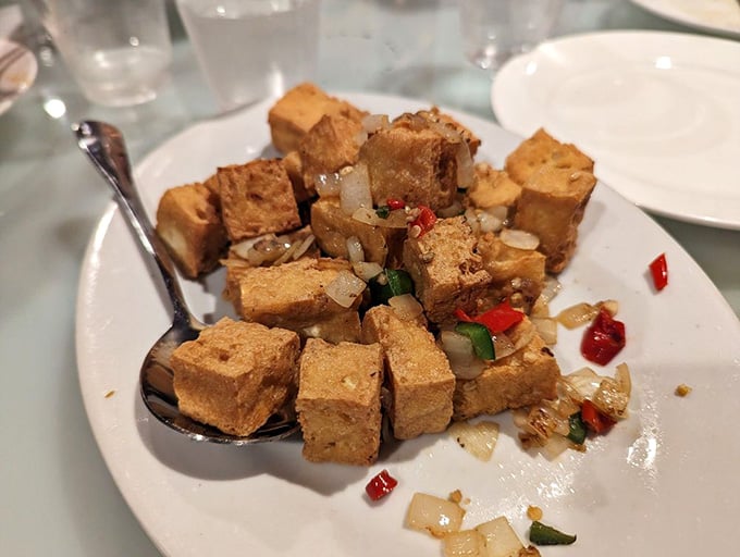 Golden cubes of crispy tofu tossed with peppers and onions prove that vegetarian options can absolutely steal the show.