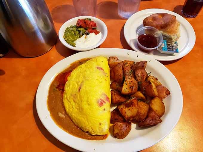 That omelet is so perfectly golden and fluffy, it's practically glowing with breakfast confidence and culinary swagger.