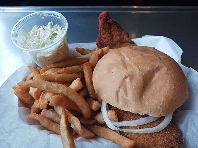 Behold the fish sandwich that laughs in the face of structural engineering and makes grown adults reconsider their life choices.
