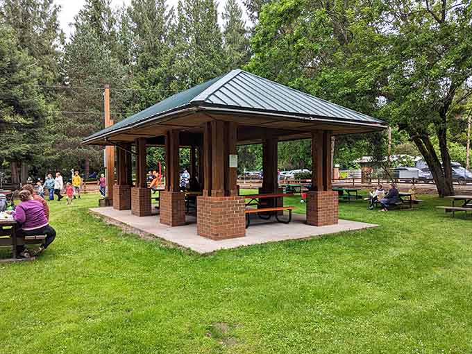 The park's brick-columned pavilion offers shaded picnic spots where families gather between rides and make memories.
