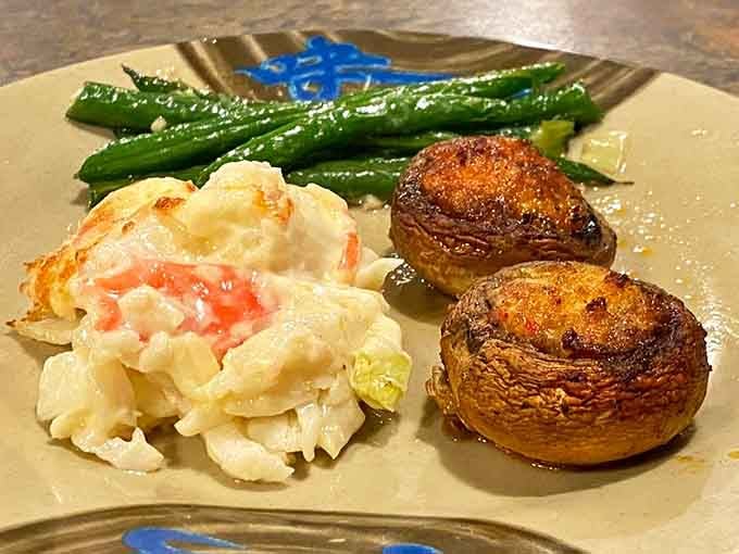 Stuffed mushrooms and baked crab sitting pretty, proving that buffet food can absolutely have sophisticated aspirations.