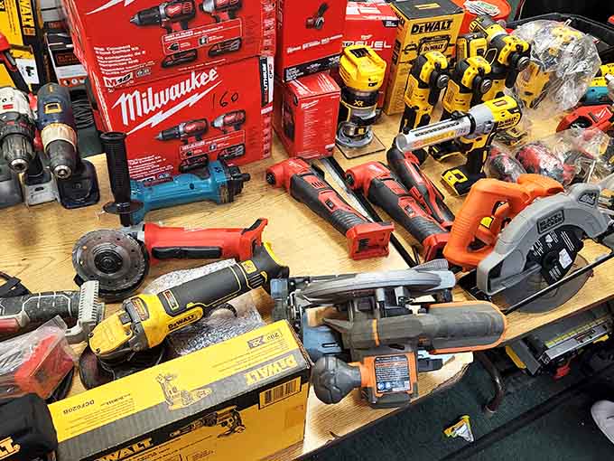 Milwaukee and DeWalt power tools spread across the counter like a handyman's version of Christmas morning arrived early.