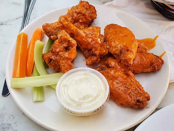Golden, crispy buffalo wings served with cool blue cheese dressing&mdash;this is what happiness looks like on a plate.