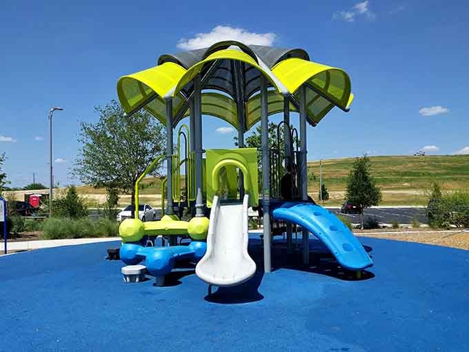 Colorful canopies shade this playground structure where slides promise quick descents and endless repeat visits.