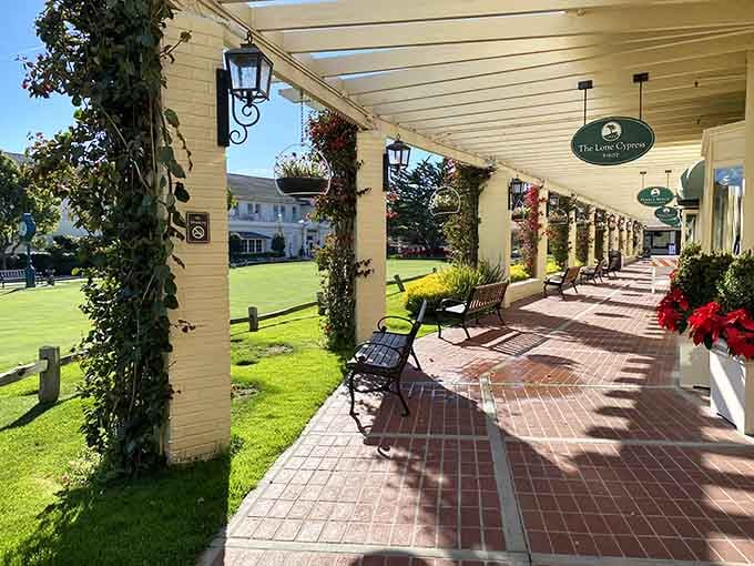 The walkway to greatness, lined with flowers that somehow survived the coastal winds better than your scorecard will.