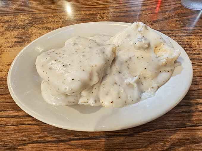 Behold the star of the show: fluffy biscuits drowning in creamy sausage gravy that'll make you reconsider your life choices.