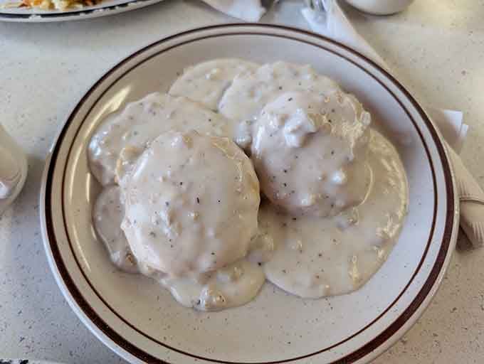 Two fluffy biscuits drowning in creamy sausage gravy, this is what breakfast dreams are made of, folks.
