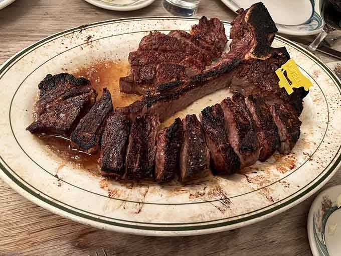 Behold the porterhouse, pre-sliced and swimming in butter, looking like edible perfection achieved its final form.