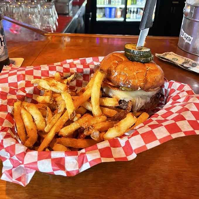 Behold the burger that earned its dramatic name, complete with enough toppings to require architectural engineering skills.