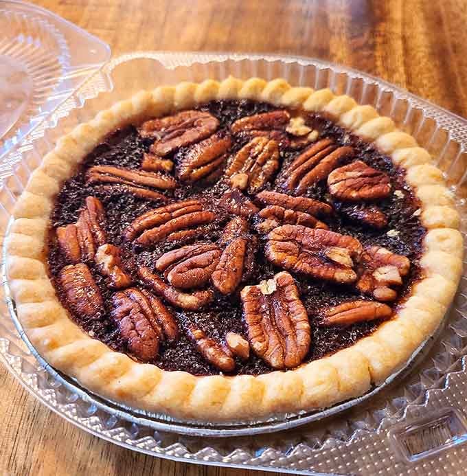 Classic pecan pie with that perfect nutty crown, looking like edible artwork in a flaky frame.