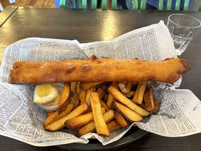 Behold the platonic ideal of fish and chips: golden, crispy, and served on newspaper like the British intended.