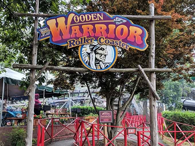 The Wooden Warrior sign beckons brave souls to experience classic coaster thrills through the trees.