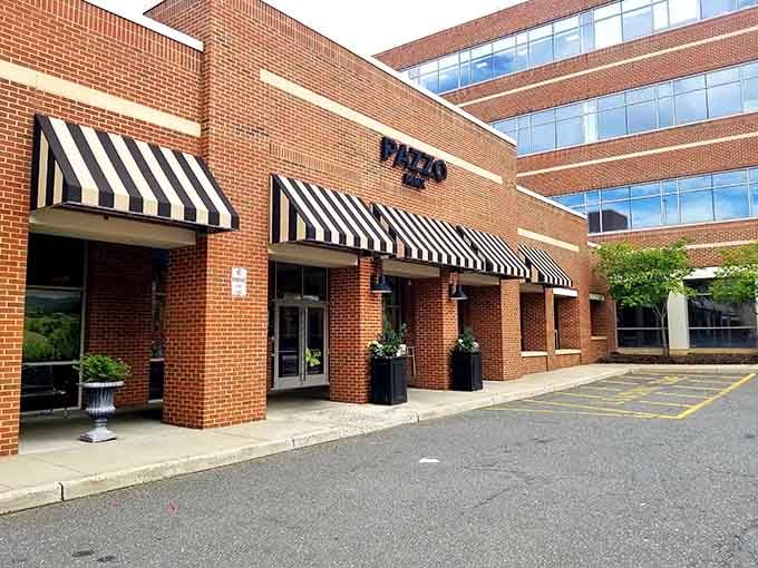 Those classic black-and-white awnings signal serious dining ahead, like something straight out of a Fellini film.