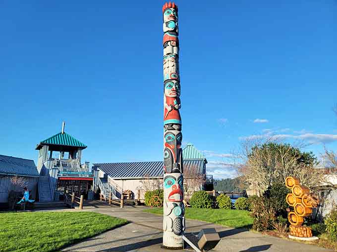 This towering totem pole stands guard over the waterfront like a wooden sentinel with serious artistic credentials.
