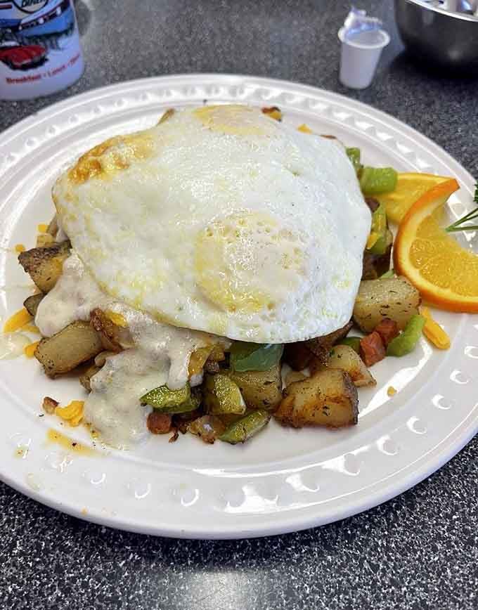 That perfectly runny egg draped over crispy potatoes and peppers is breakfast poetry on a plate.